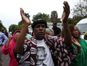 Singing, dancing Sowetans pay tribute outside Mandela's old home