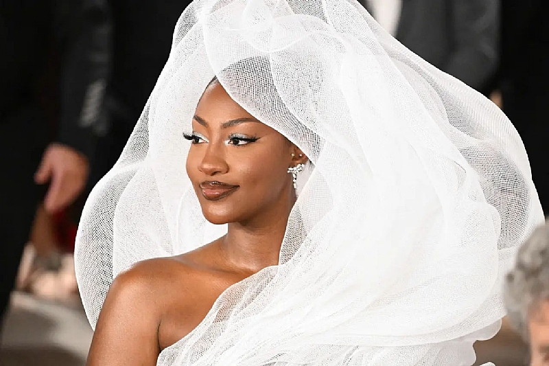 Tems causes stir with view-blocking outfit at Oscars