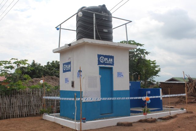Plan Int'l hands over borehole to four communities