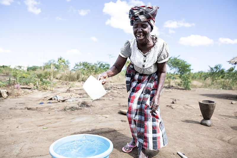 Merina scoops fresh water from the newly rehabilitated borehole – the ...