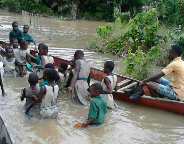 Photos: Pupils swim to school in Shama Dist.